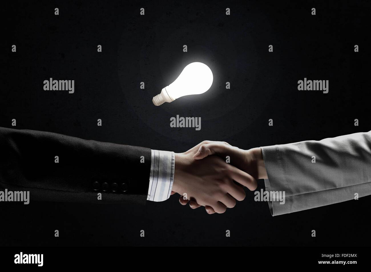 Business partners handshake glowing light hi-res stock photography and images - Alamy
