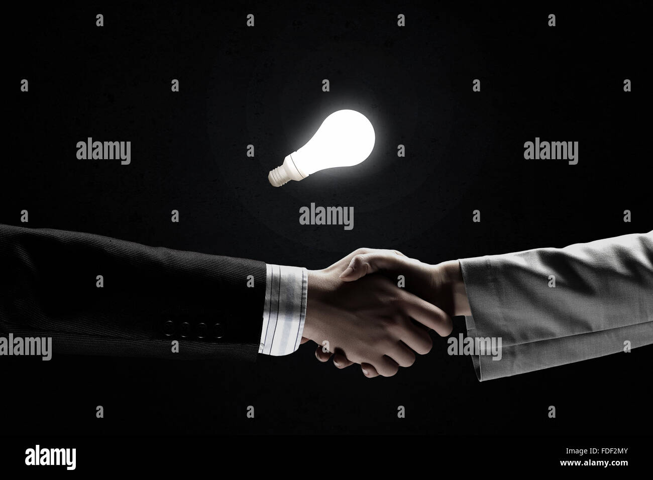 Business partners handshake glowing light hi-res stock photography and ...