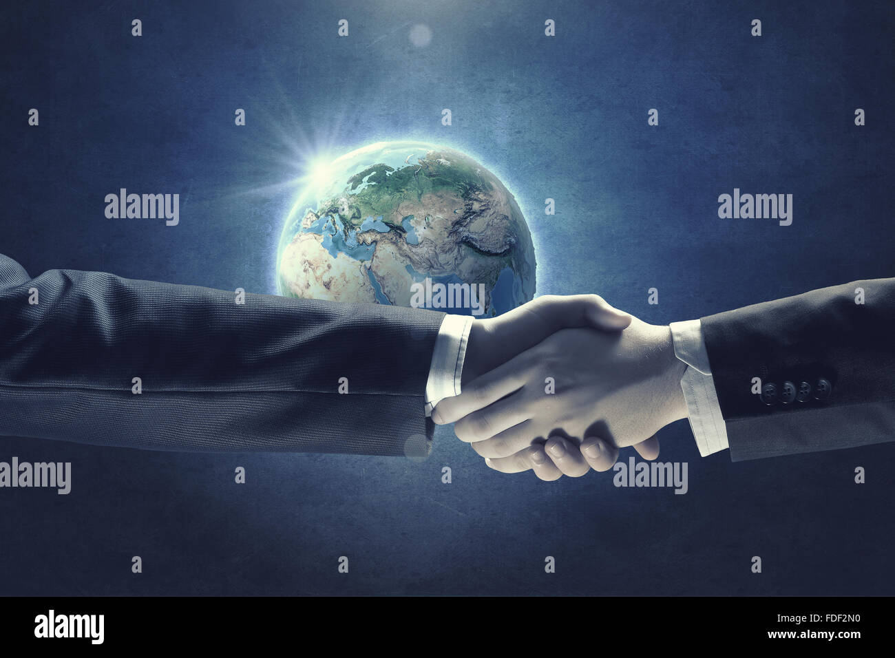 Close up of business handshake and planet Earth on background. Elements ...