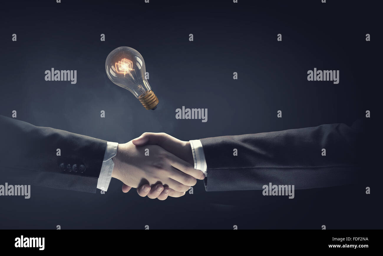 Business partners handshake glowing light hi-res stock photography and images - Alamy