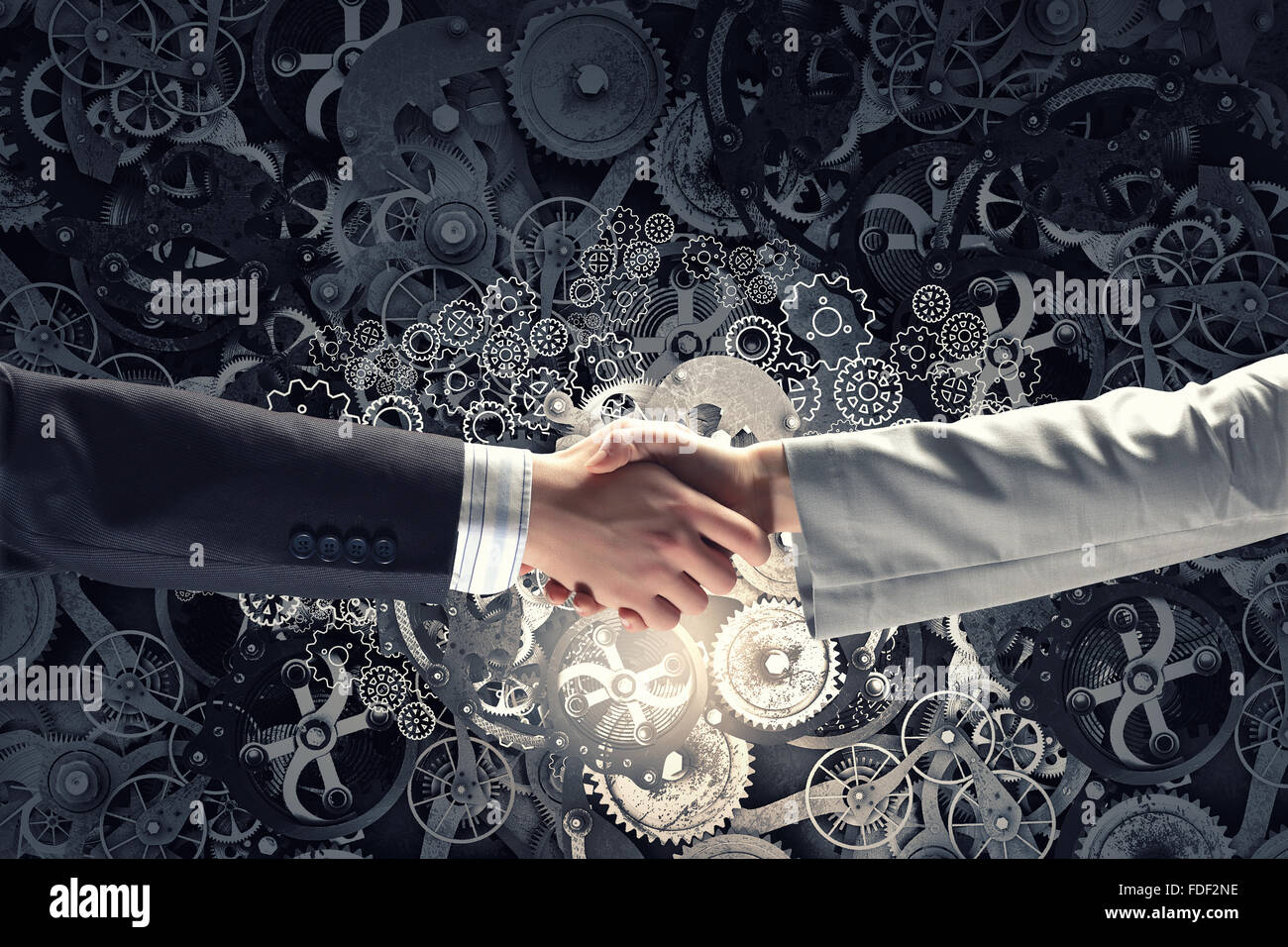 Business partners handshake and gears mechanism on background Stock ...