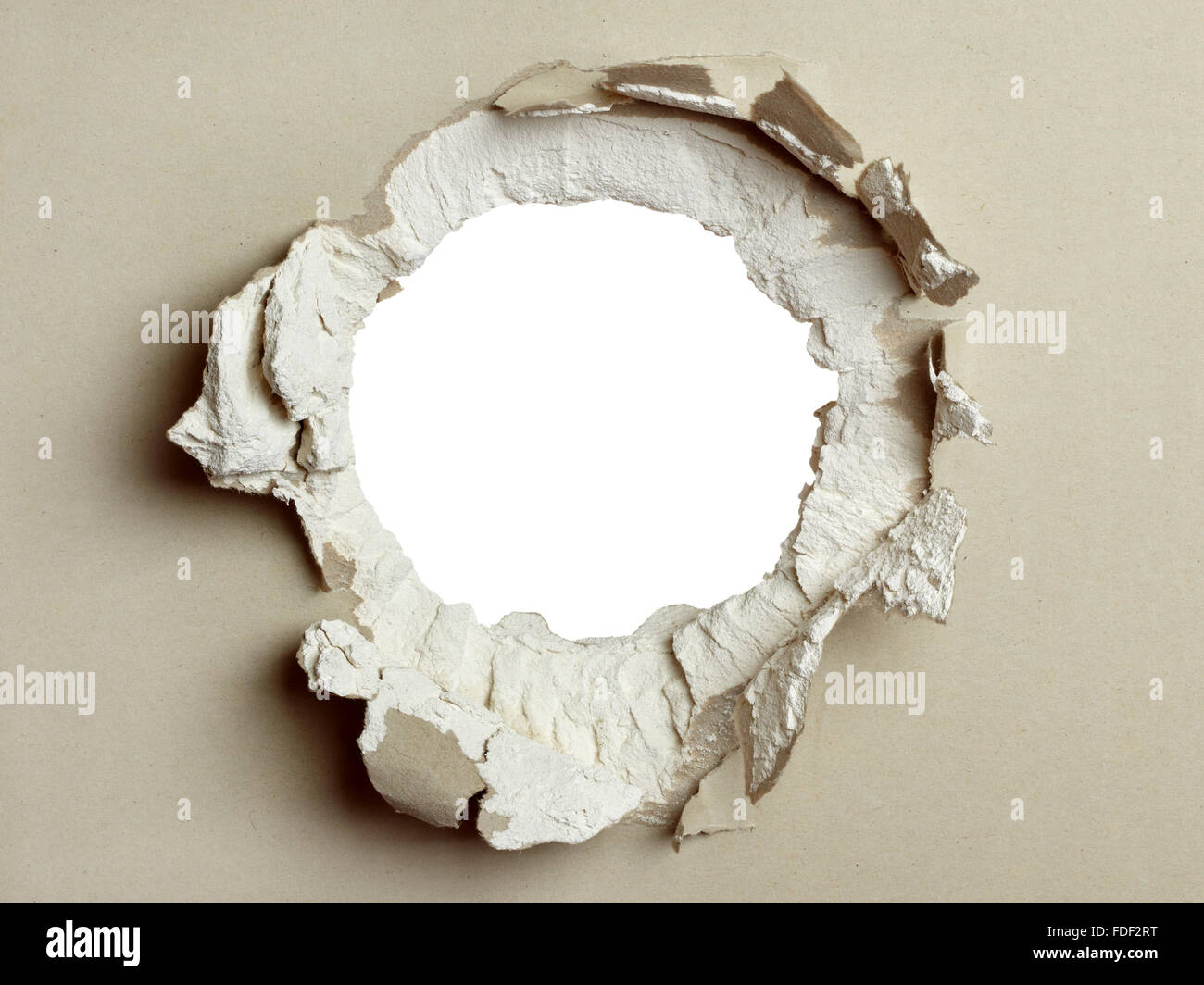 Hole in the grey plasterboard with uneven edges Stock Photo - Alamy