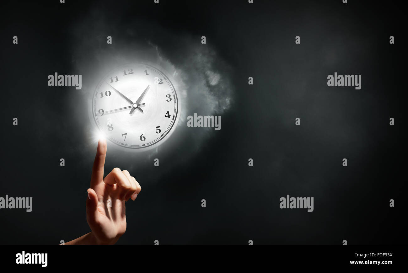 Close up of man hand pointing at clock watch symbol Stock Photo - Alamy