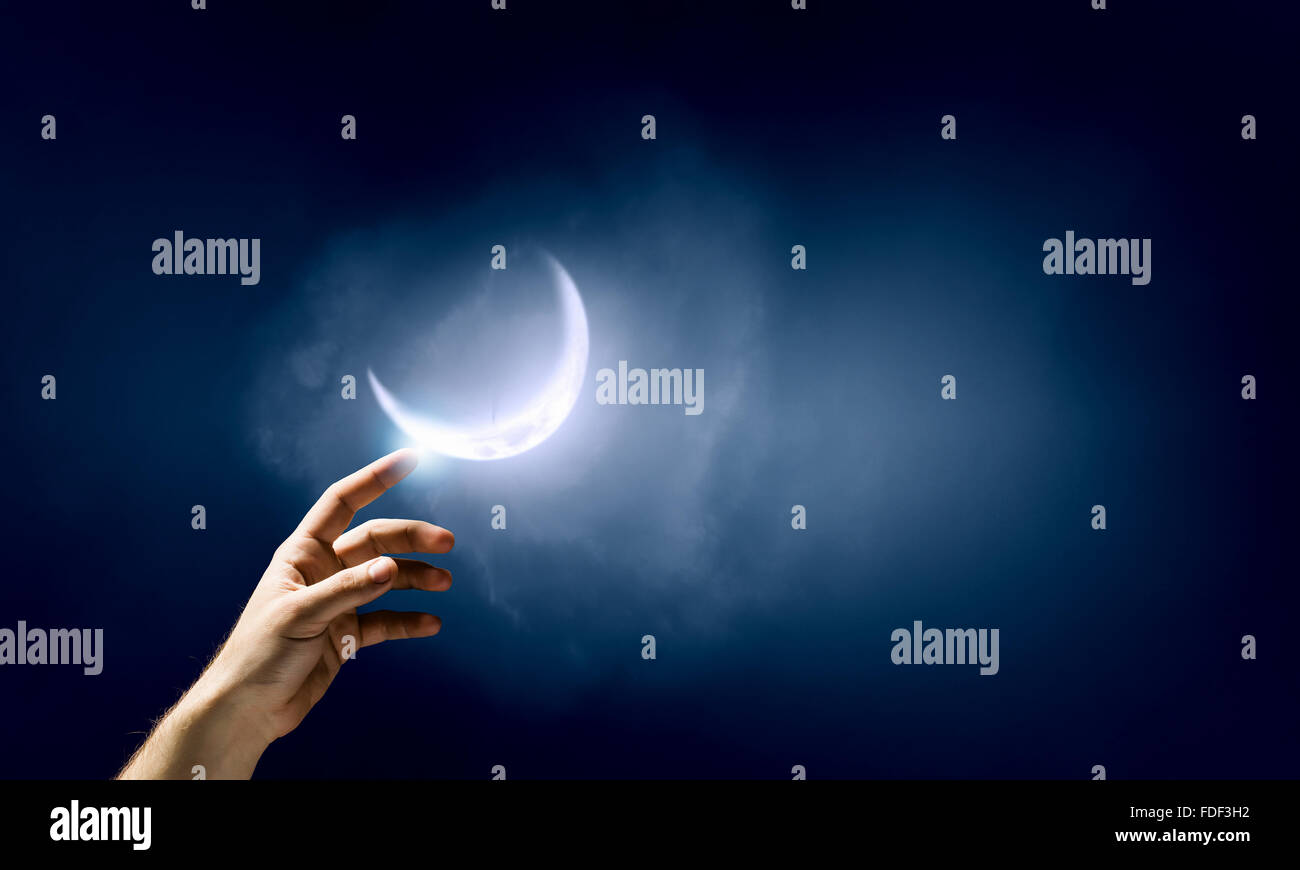 Close up of human hand touching with finger moon Stock Photo - Alamy