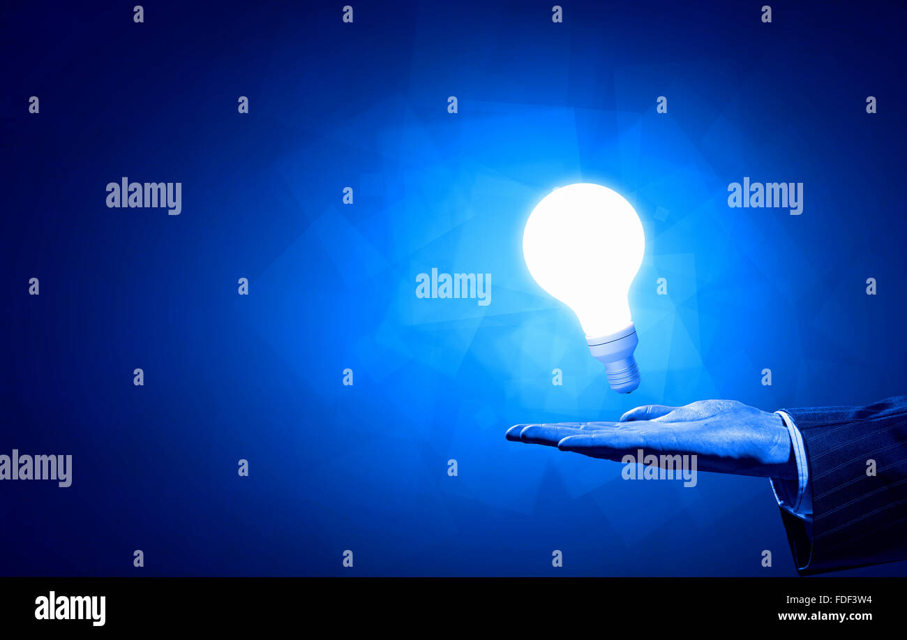 Close up of human hand holding light bulb in palm Stock Photo - Alamy