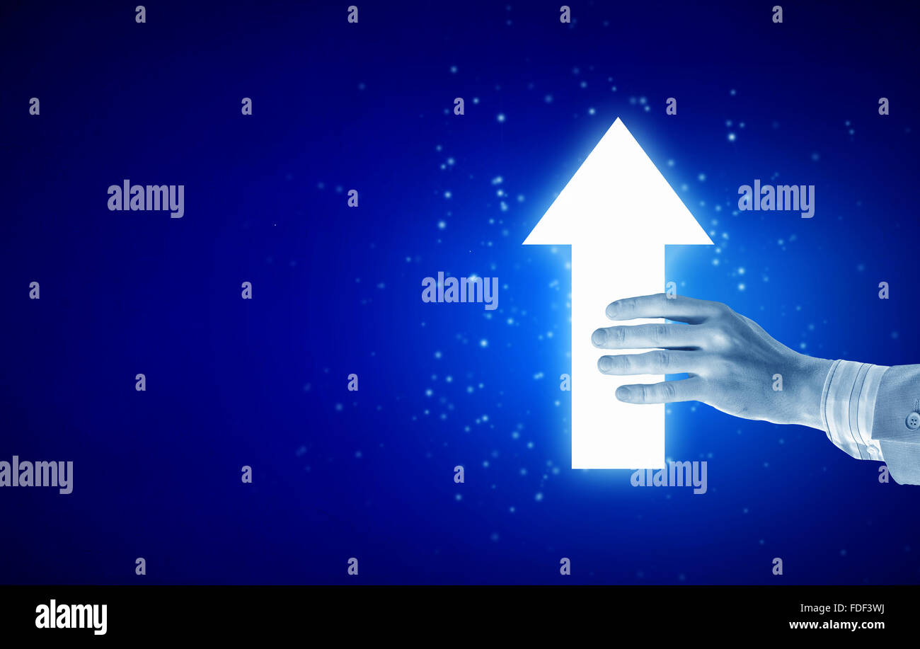 Close up of human hand with arrow icon on blue background Stock Photo ...