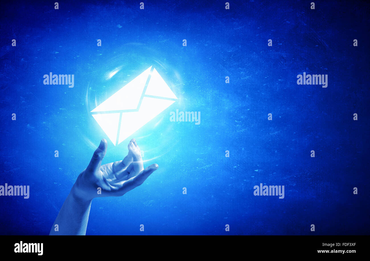 Close up of human hand and email icon in palm on blue background Stock ...