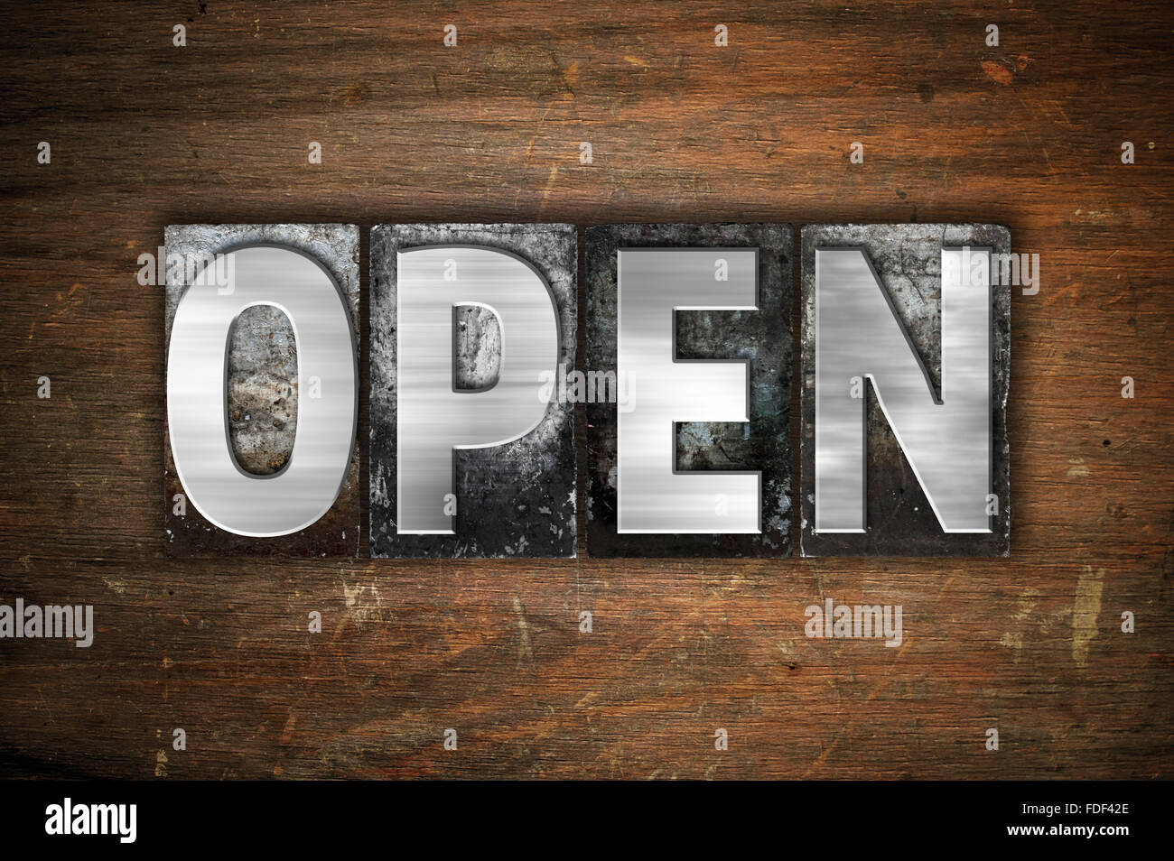 The word "Open" written in vintage metal letterpress type on an aged ...