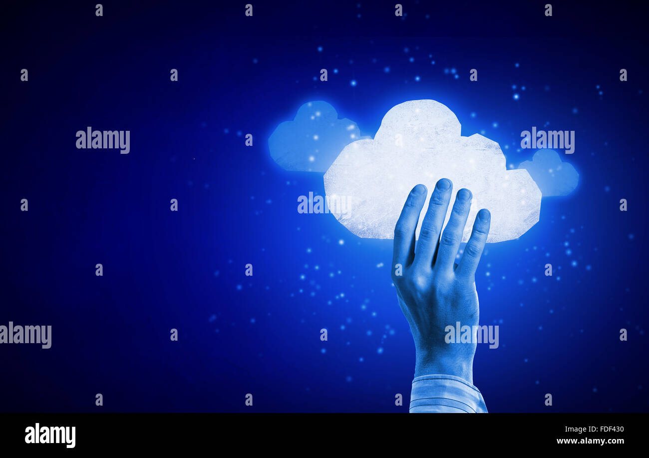 Person hand touching glowing cloud on blue background Stock Photo - Alamy