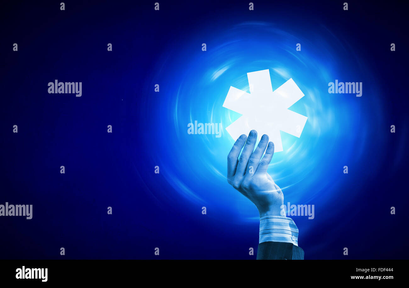 Hand holding medicine sign on blue screen Stock Photo - Alamy