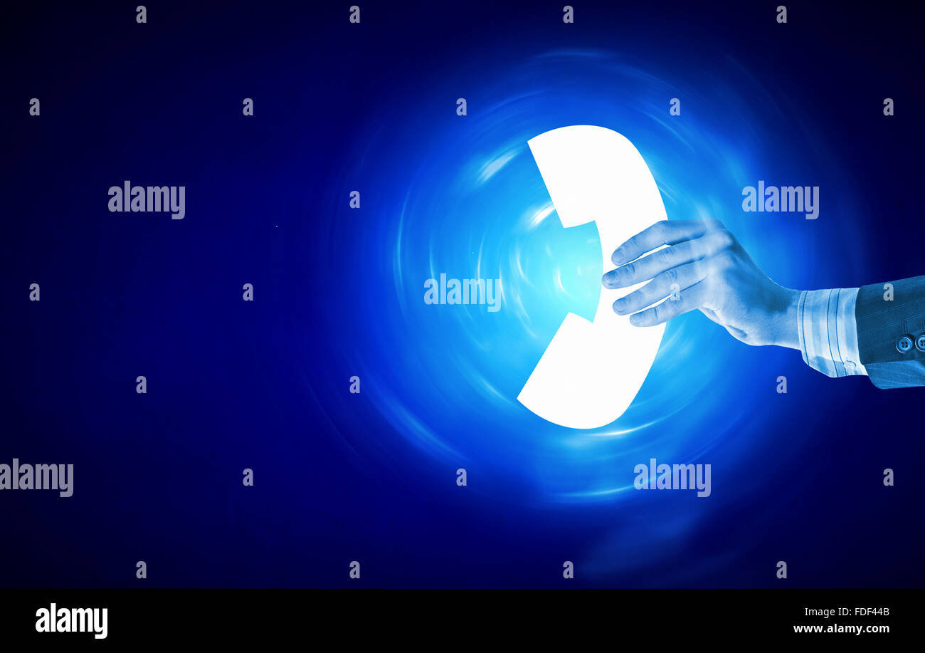 Businessman hand holding calls icon on blue background Stock Photo - Alamy