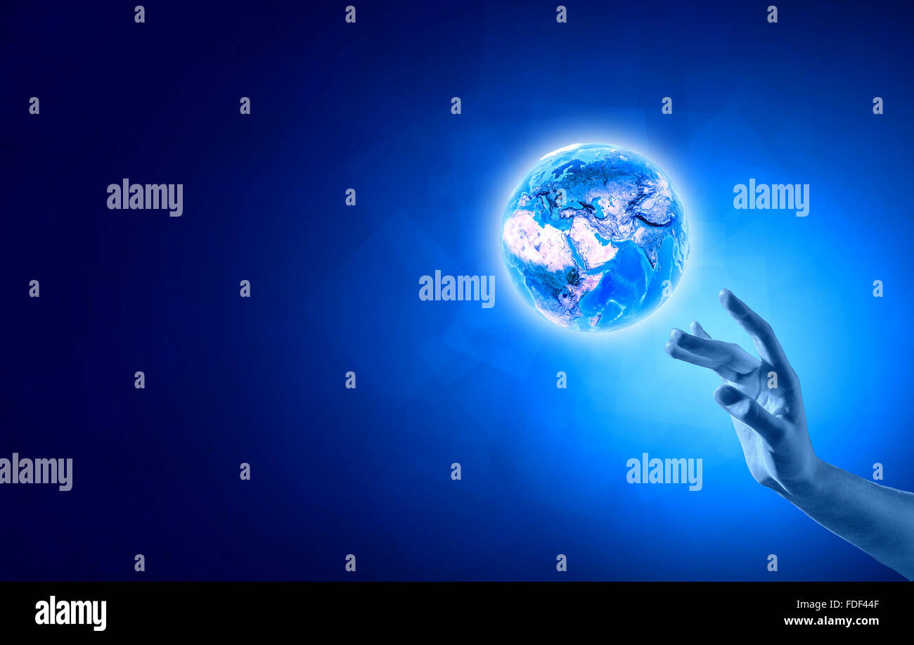 Close up of human hand touching Earth planet with finger. Elements of ...