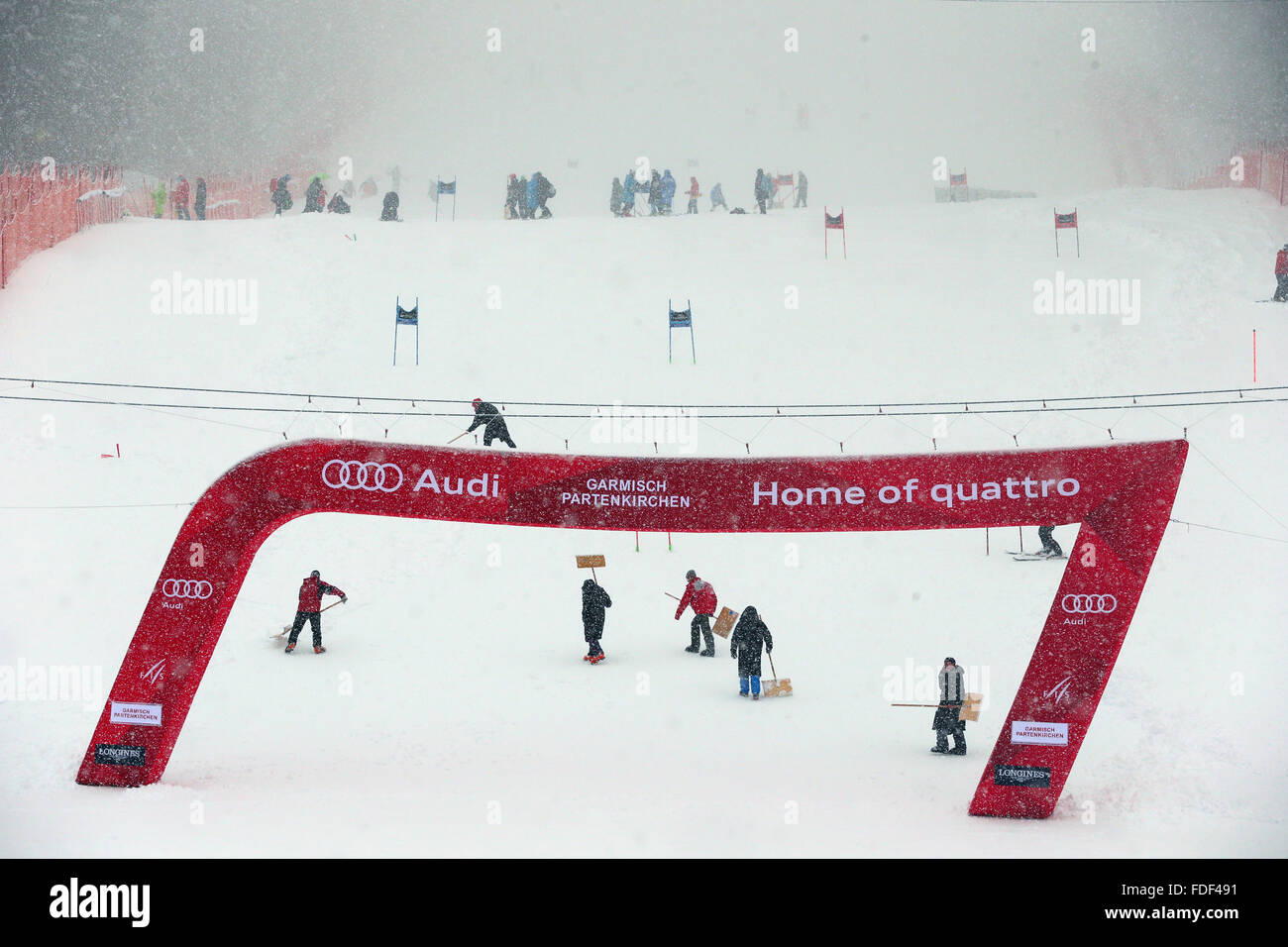 Garmisch Partenkirchen, Germany. 31st Jan, 2016. Helpers use shovels to ...