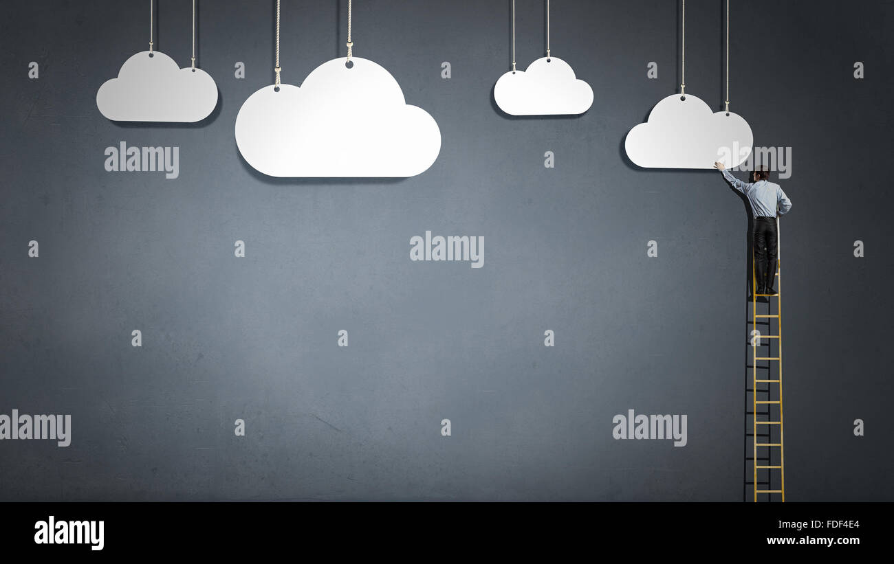 Businessman climbing ladder to top and touching cloud Stock Photo - Alamy