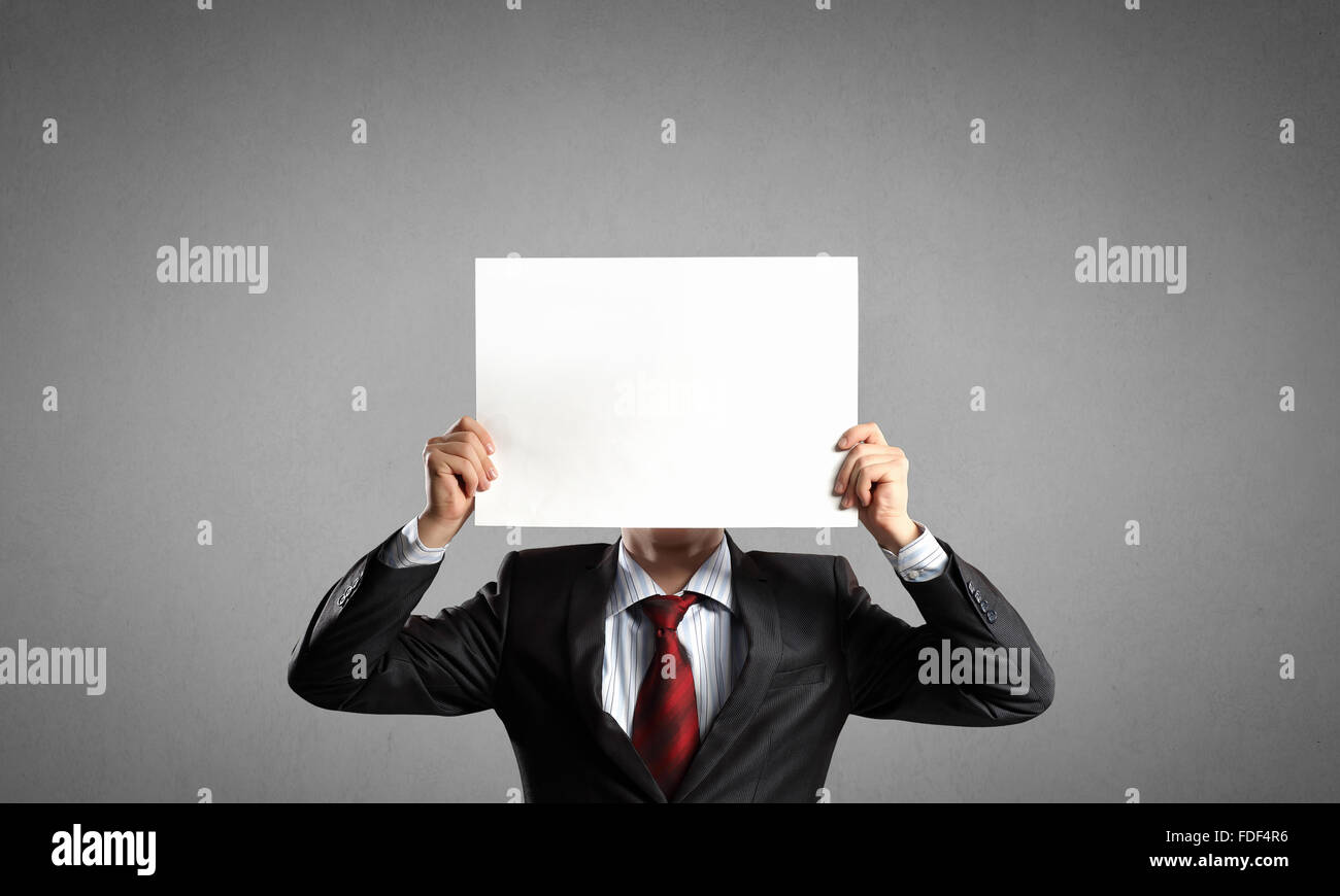 Businessman hiding his face behind paper list Stock Photo - Alamy