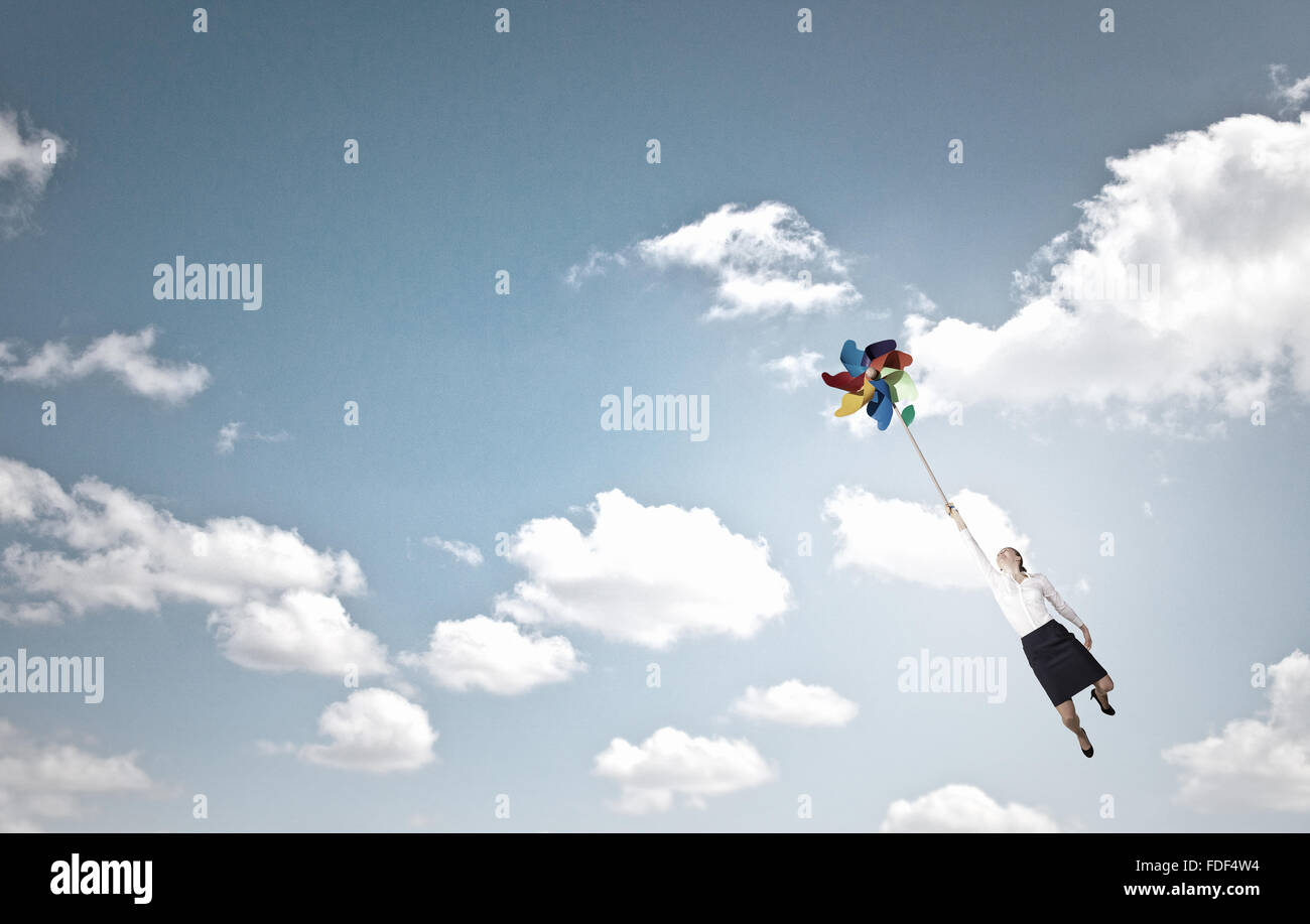 Beautiful young caucasian businesswoman flying on windmill Stock Photo ...