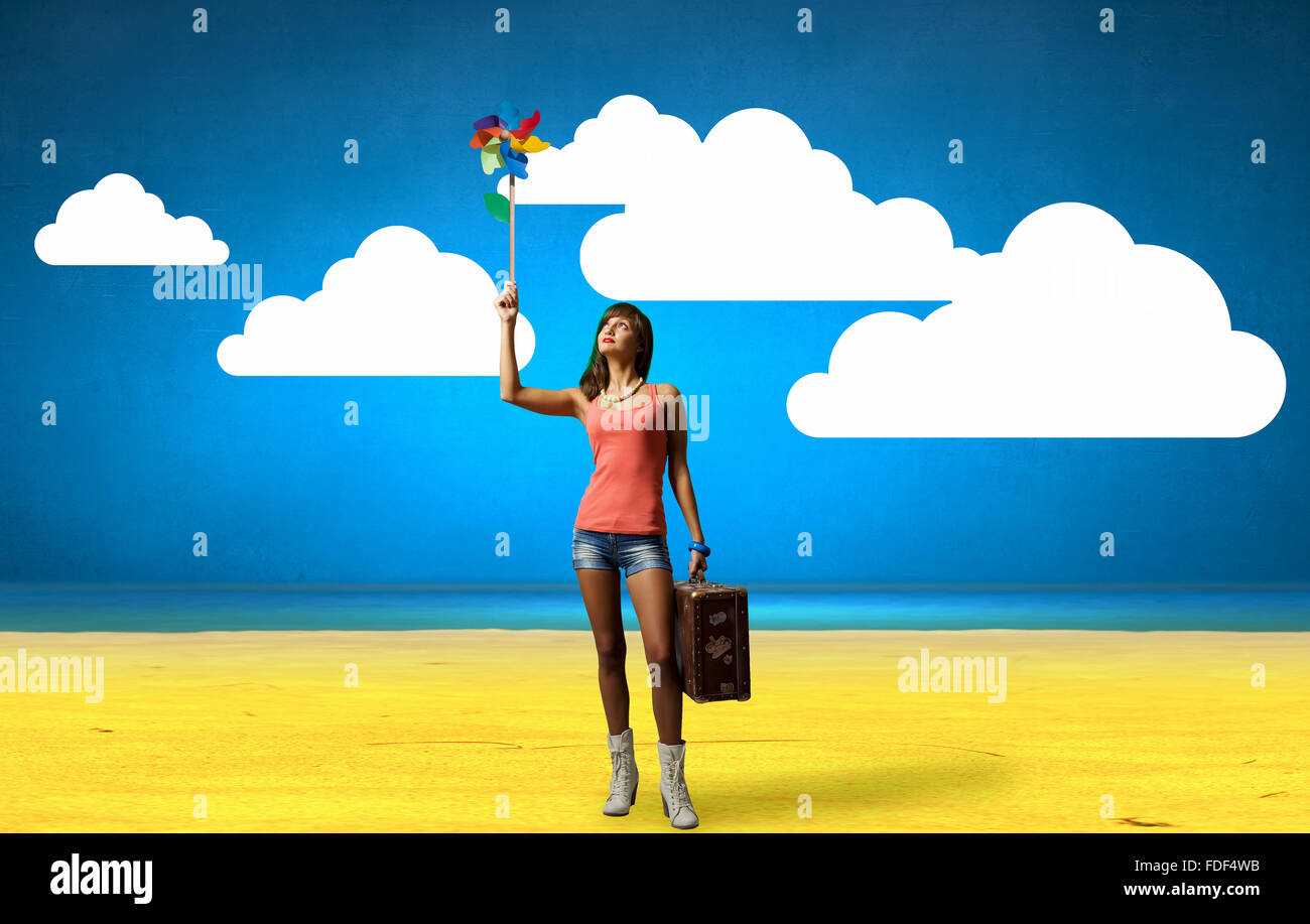 Happy young woman with windmill in hand Stock Photo - Alamy