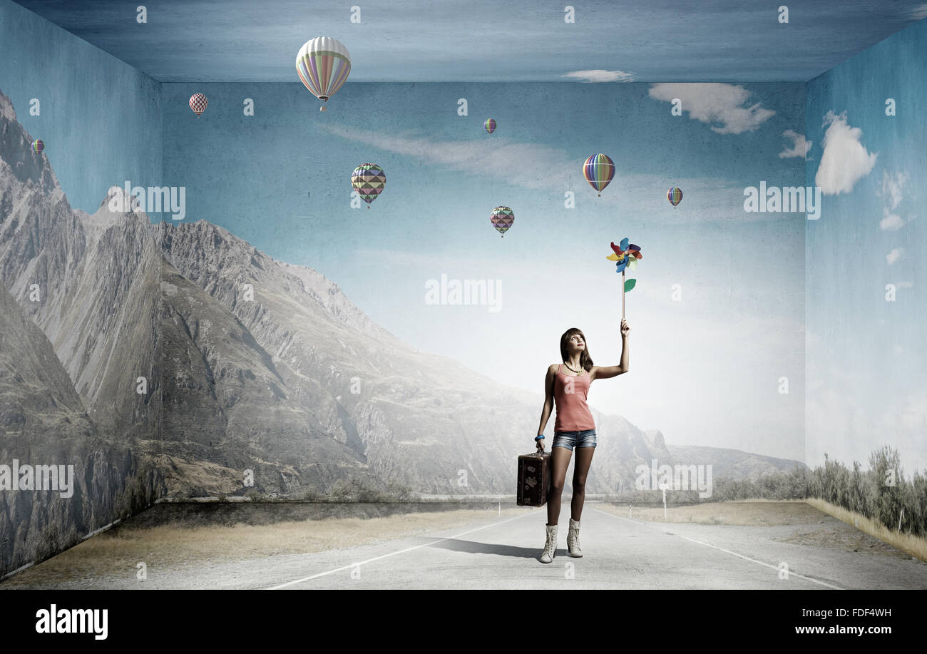 Happy young woman with windmill in hand Stock Photo - Alamy