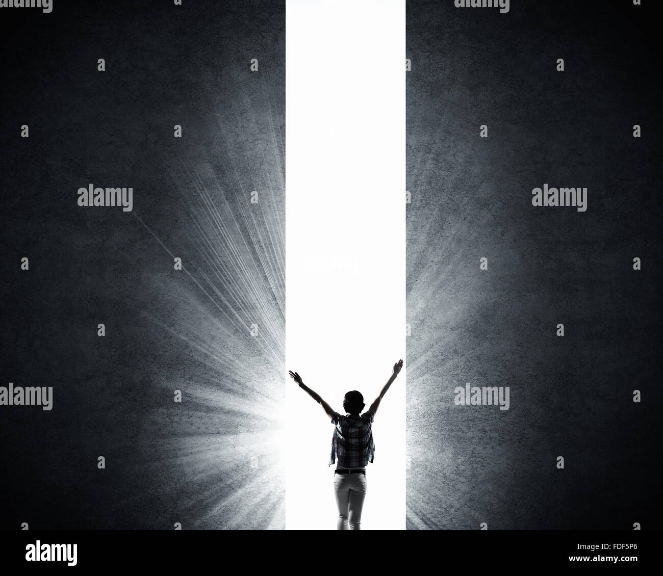 Rear view of woman with hands up facing success Stock Photo - Alamy