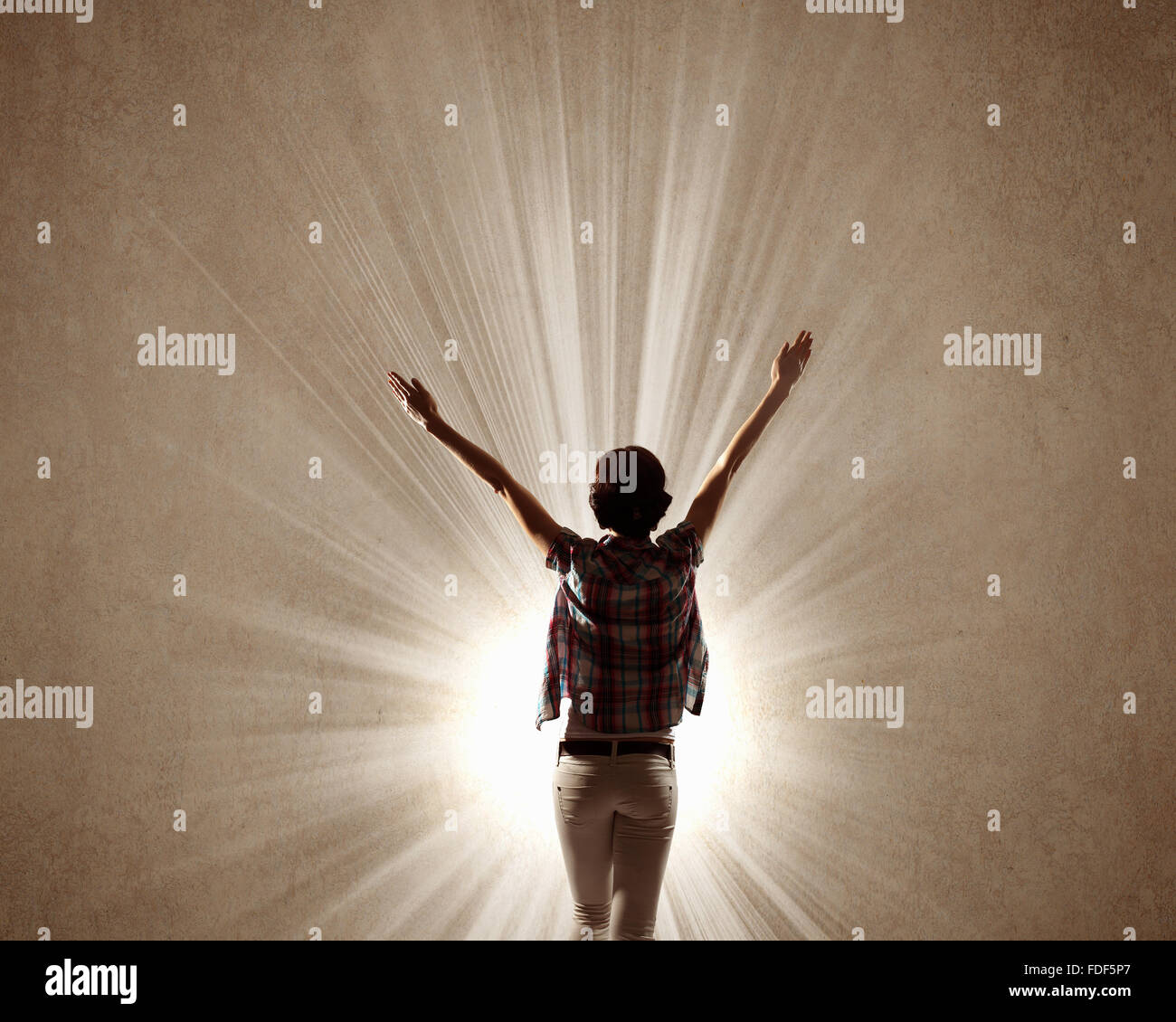 Rear view of woman with hands up facing success Stock Photo - Alamy