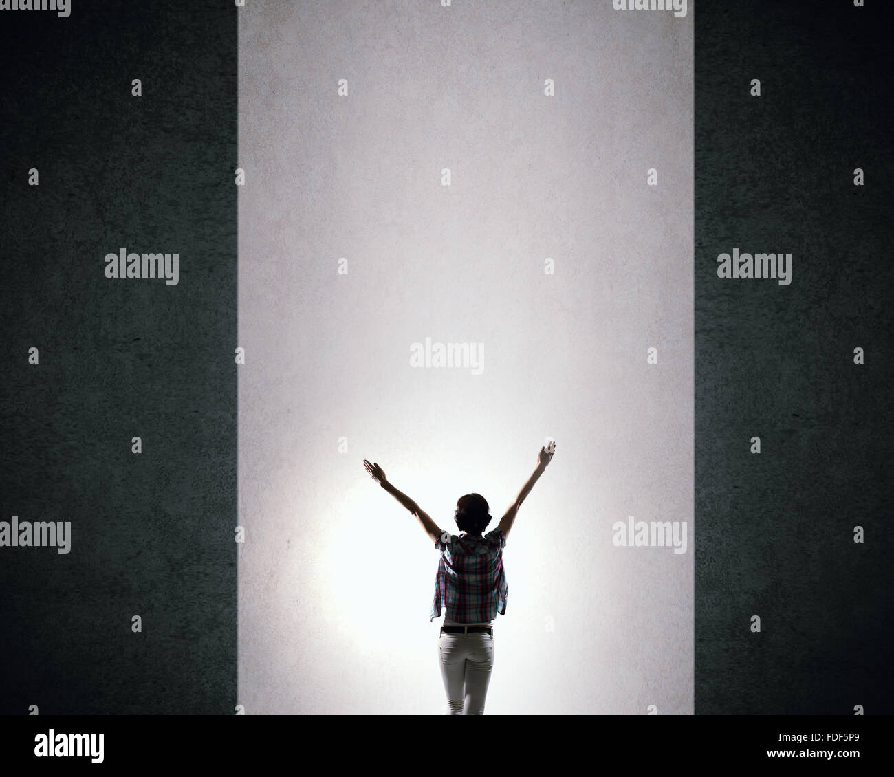 Rear view of woman with hands up facing success Stock Photo - Alamy