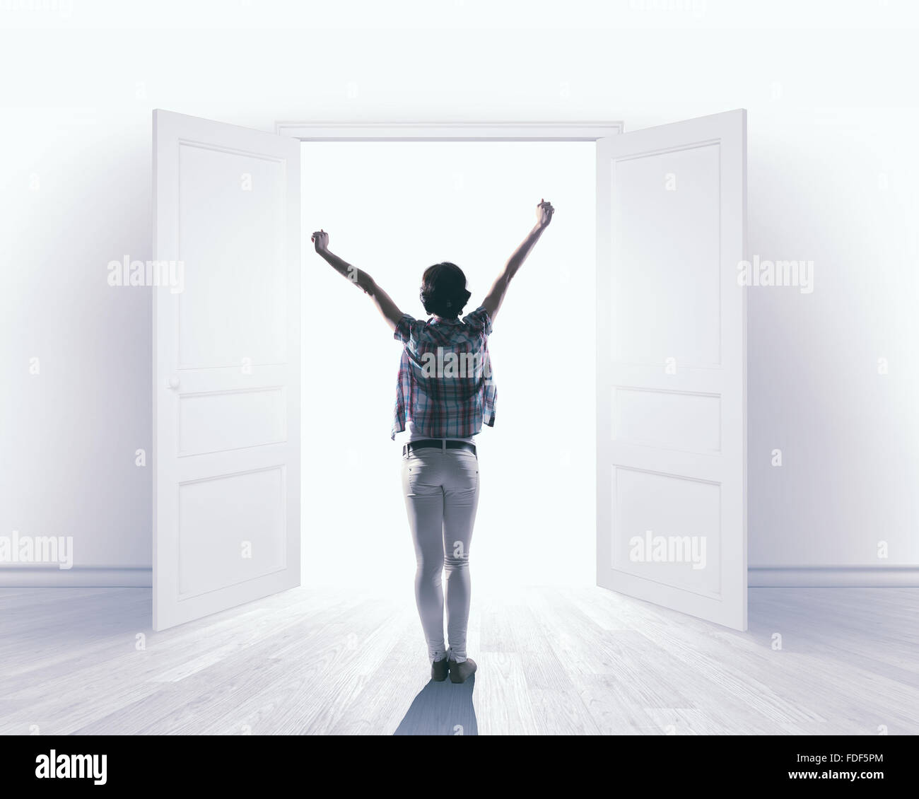 Rear view of woman with hands up entering opened door Stock Photo - Alamy