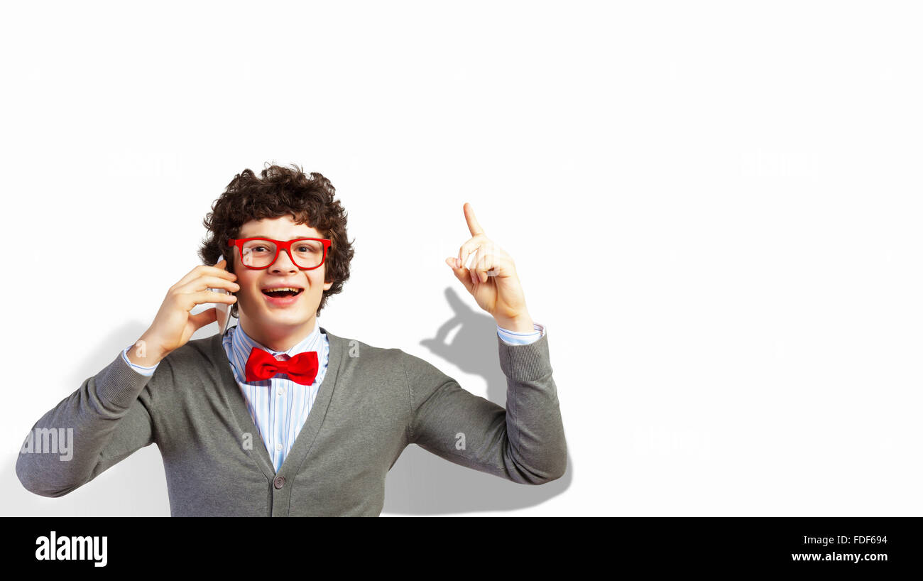 Young man talking over his mobile phone and having an idea Stock Photo ...