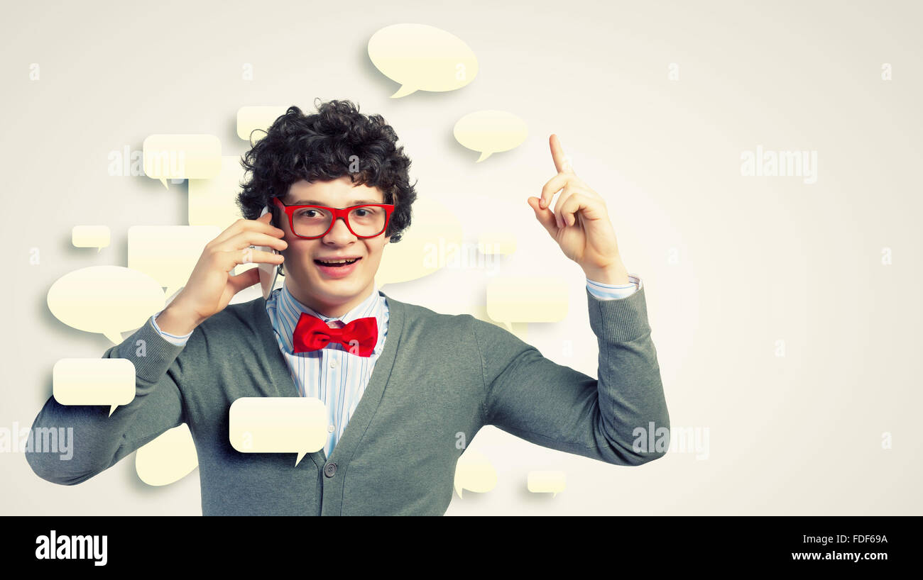 Young man talking over his mobile phone and having an idea Stock Photo ...