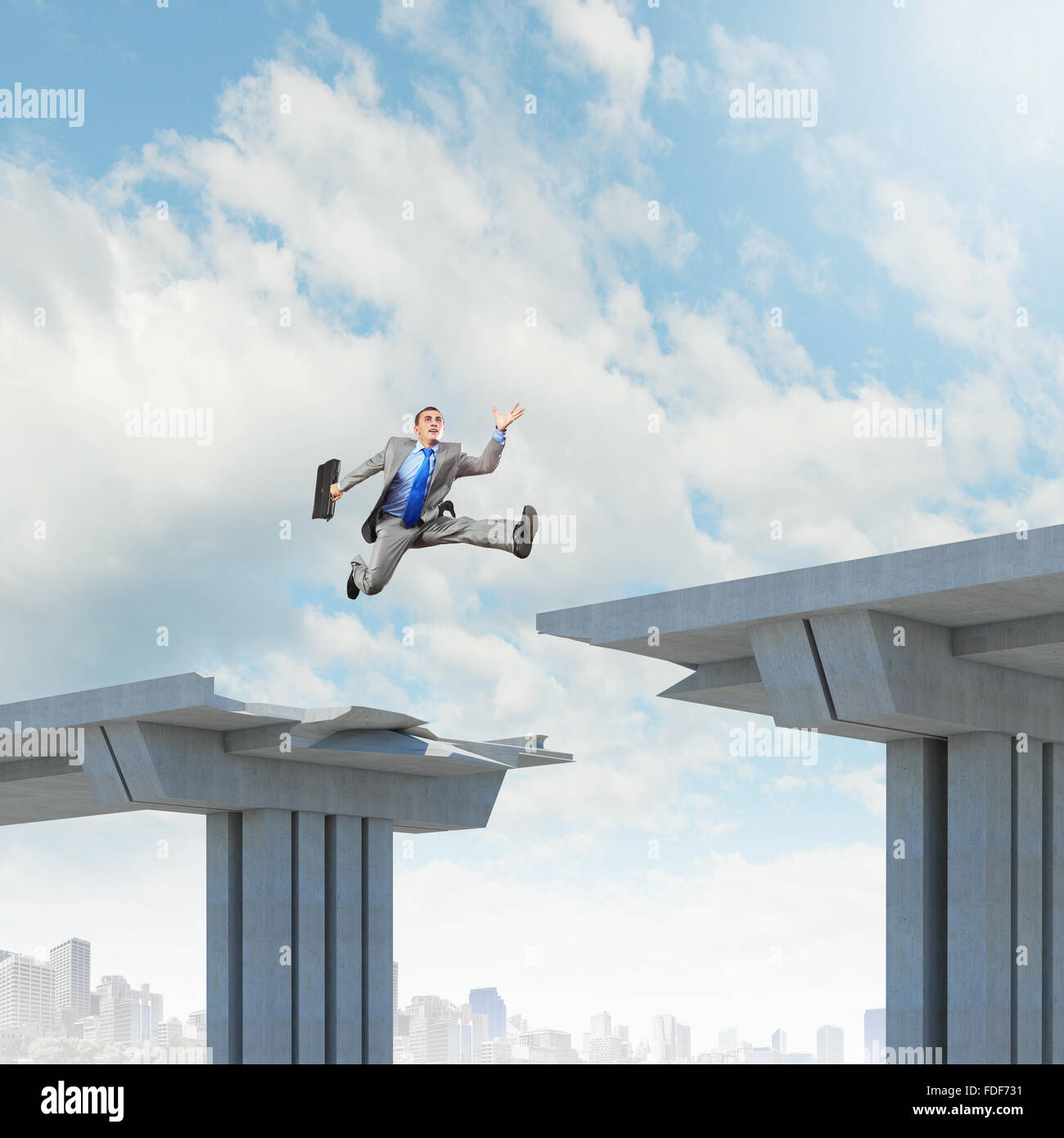 Businessman jumping over a gap in the bridge as a symbol of bridge ...