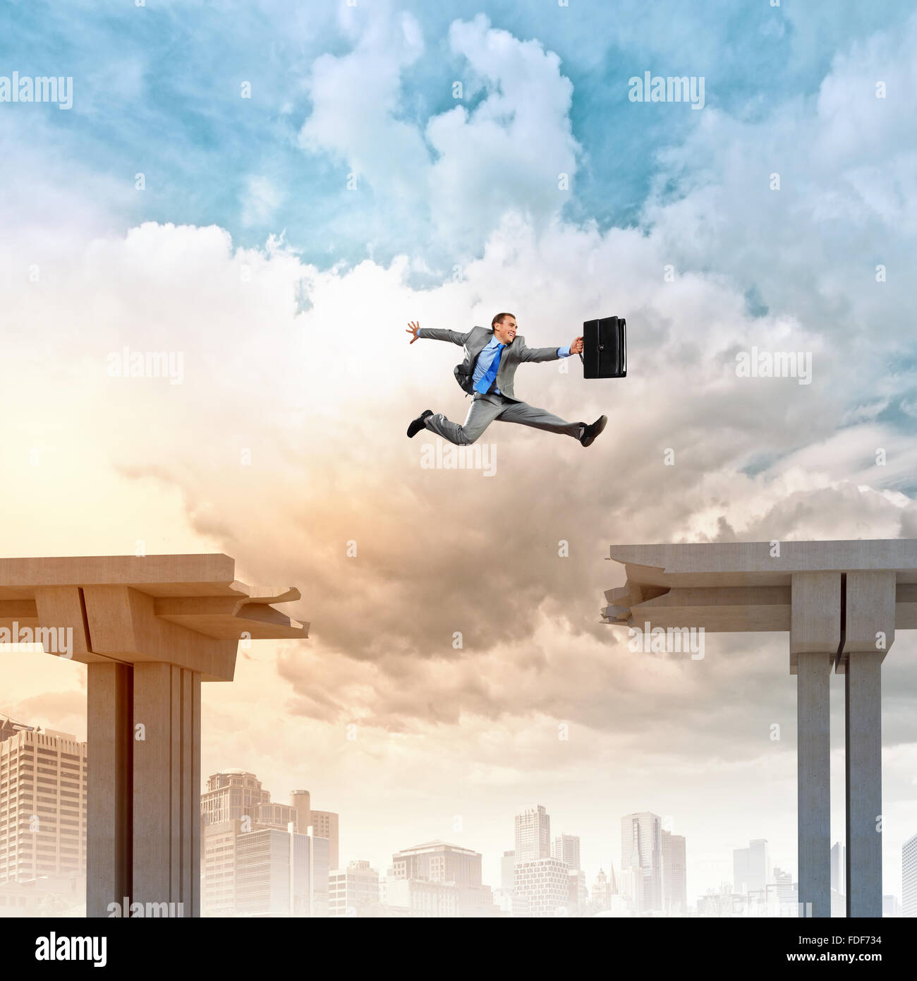 Businessman jumping over a gap in the bridge as a symbol of bridge ...