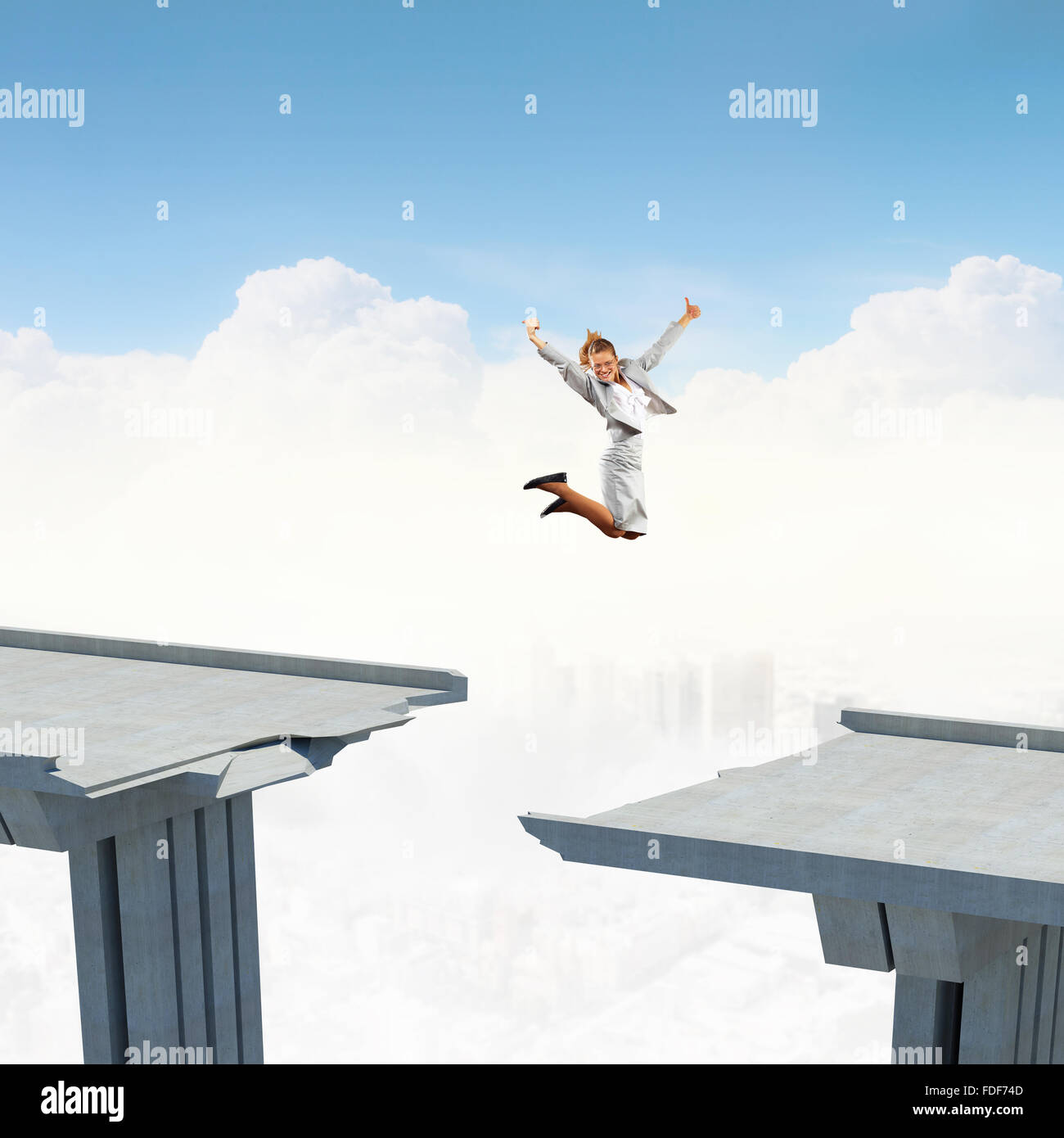 Young woman jumping over a gap in the bridge as a symbol of risk Stock ...