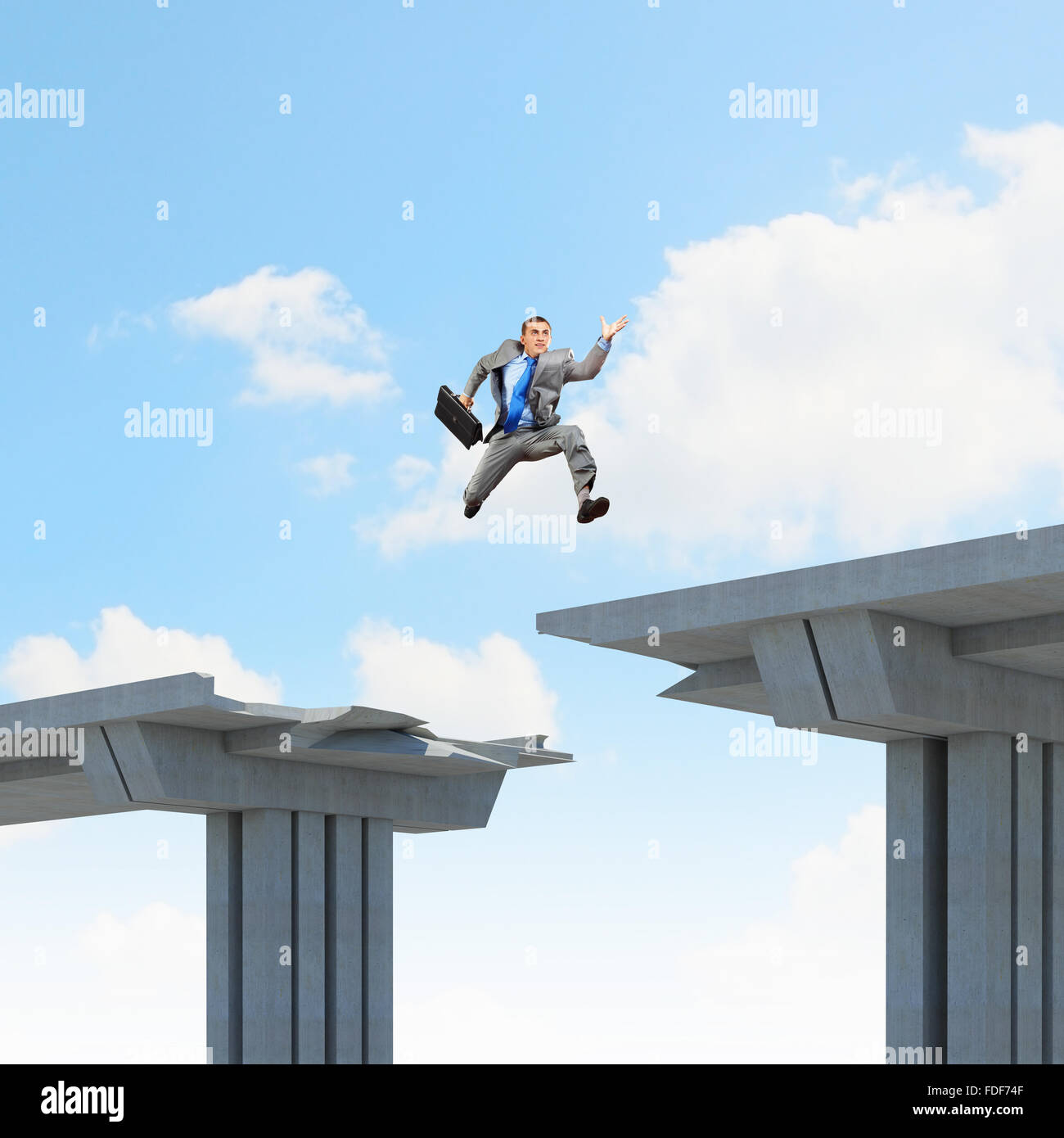 Businessman jumping over a gap in the bridge as a symbol of bridge ...