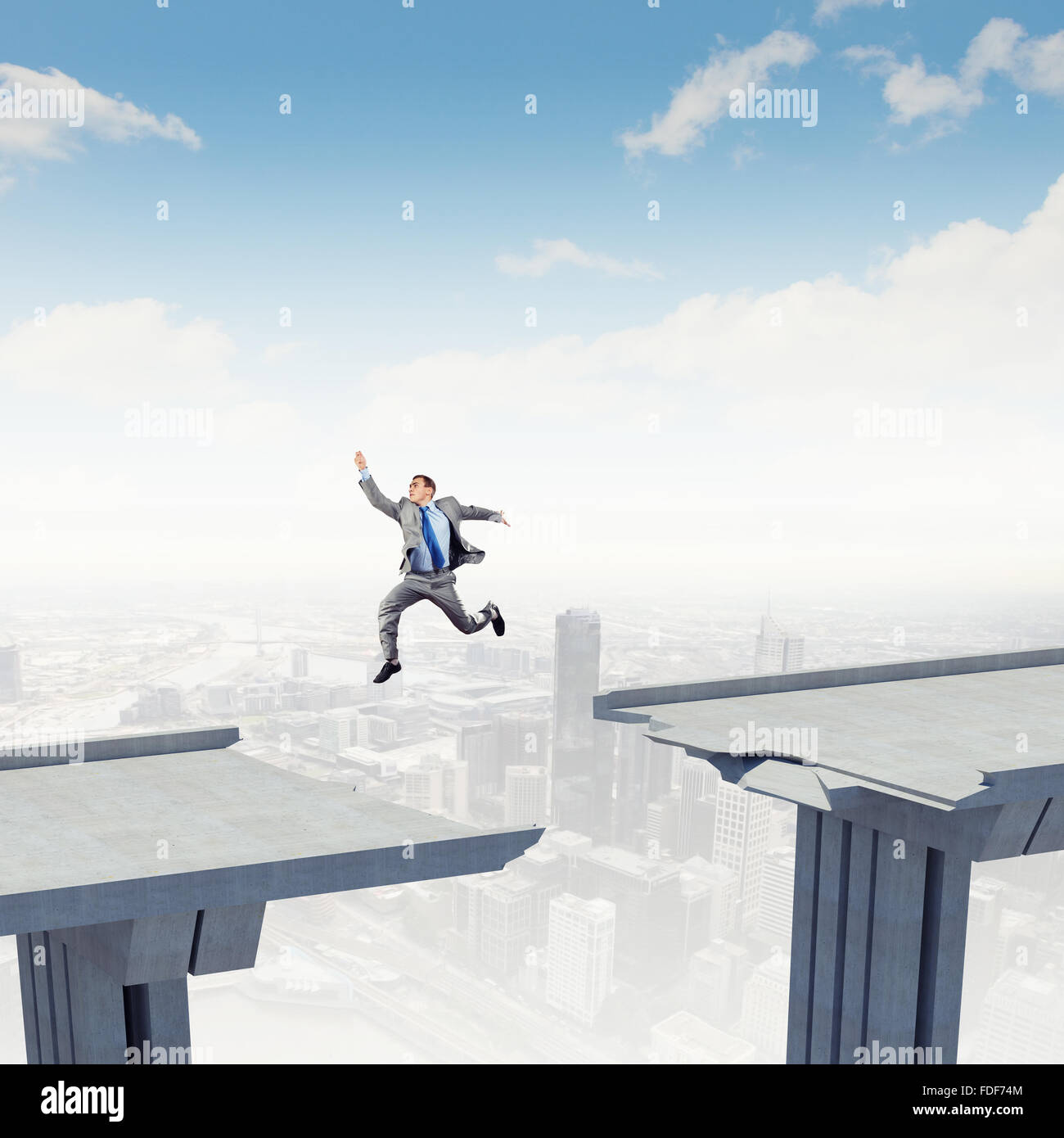Businessman jumping over a gap in the bridge as a symbol of bridge ...