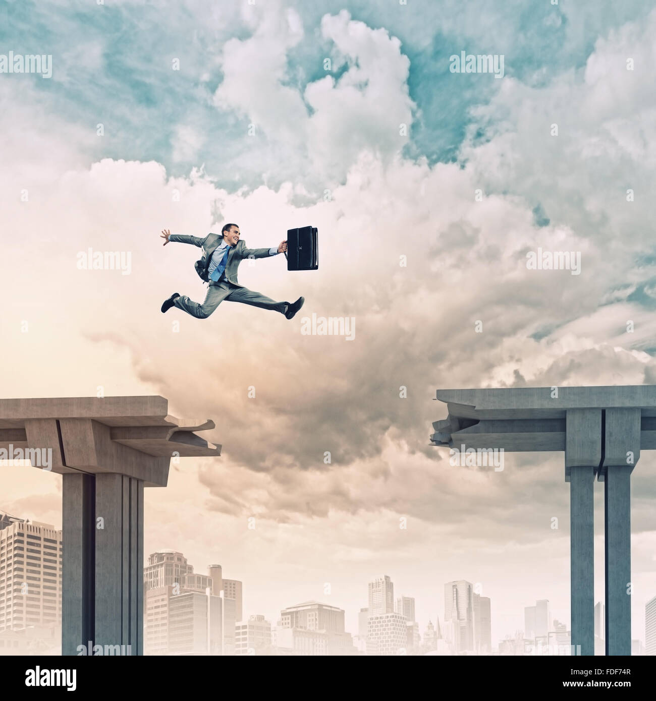 Businessman jumping over a gap in the bridge as a symbol of bridge ...