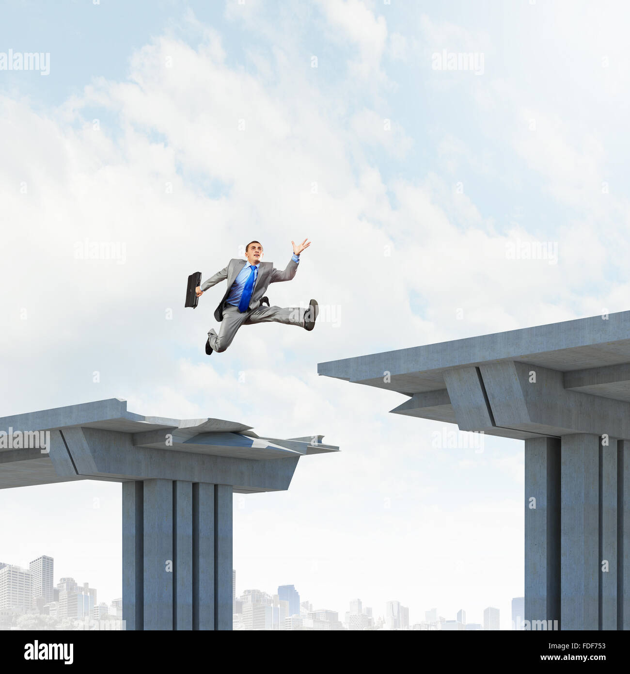 Businessman jumping over a gap in the bridge as a symbol of bridge ...