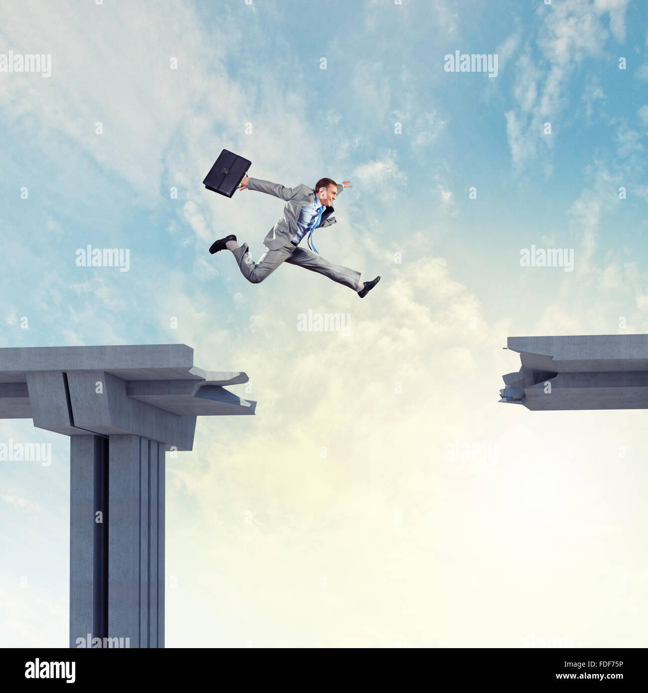Businessman jumping over a gap in the bridge as a symbol of bridge ...