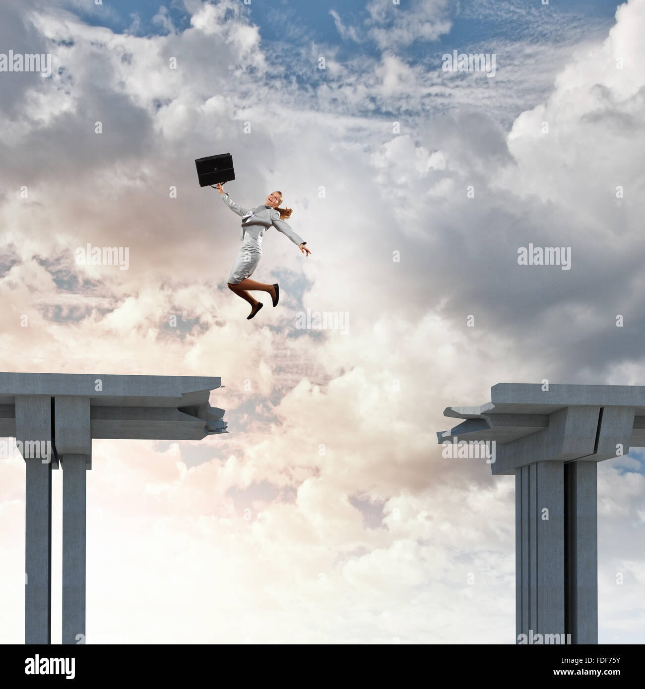 Young woman jumping over a gap in the bridge as a symbol of risk Stock ...