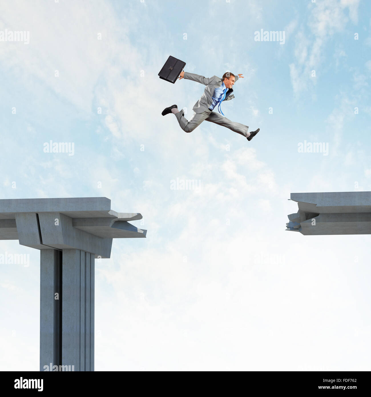 Businessman jumping over a gap in the bridge as a symbol of bridge ...