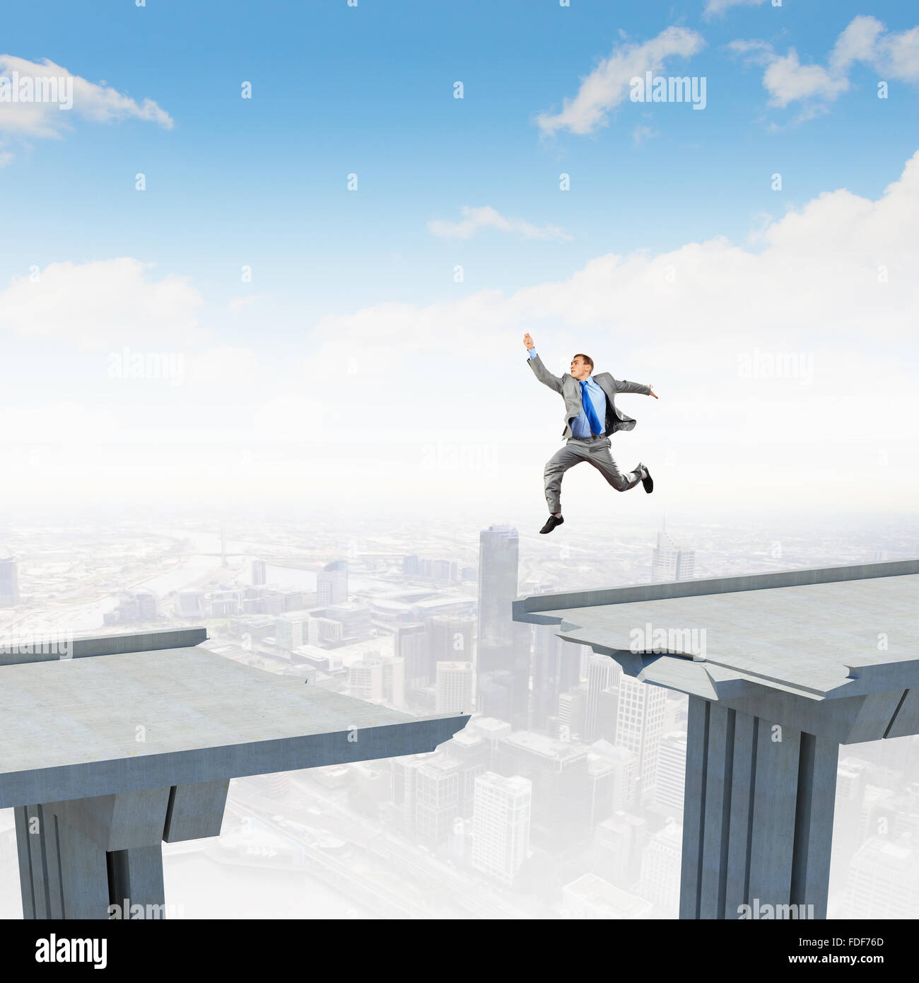 Businessman jumping over a gap in the bridge as a symbol of bridge ...