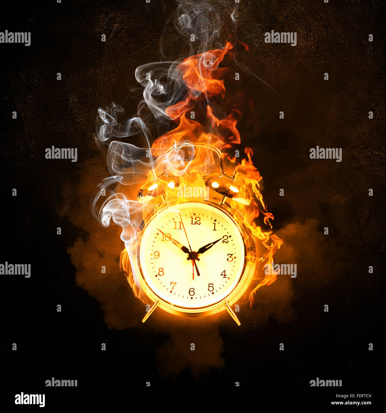 Alarm clock in fire flames. Lack of time Stock Photo - Alamy