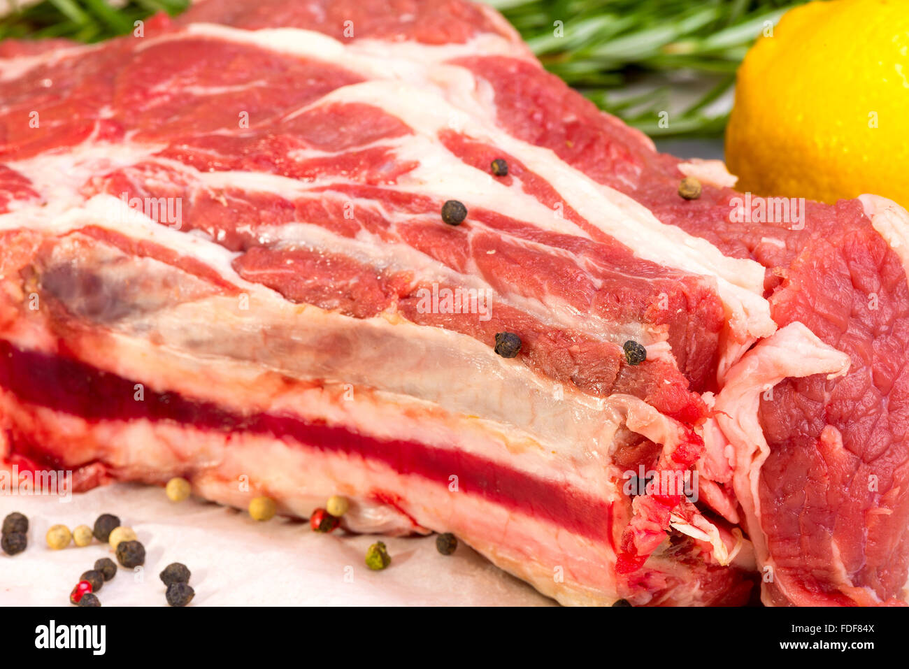 raw meat - beef. Knife, lemon and seasonings Stock Photo - Alamy