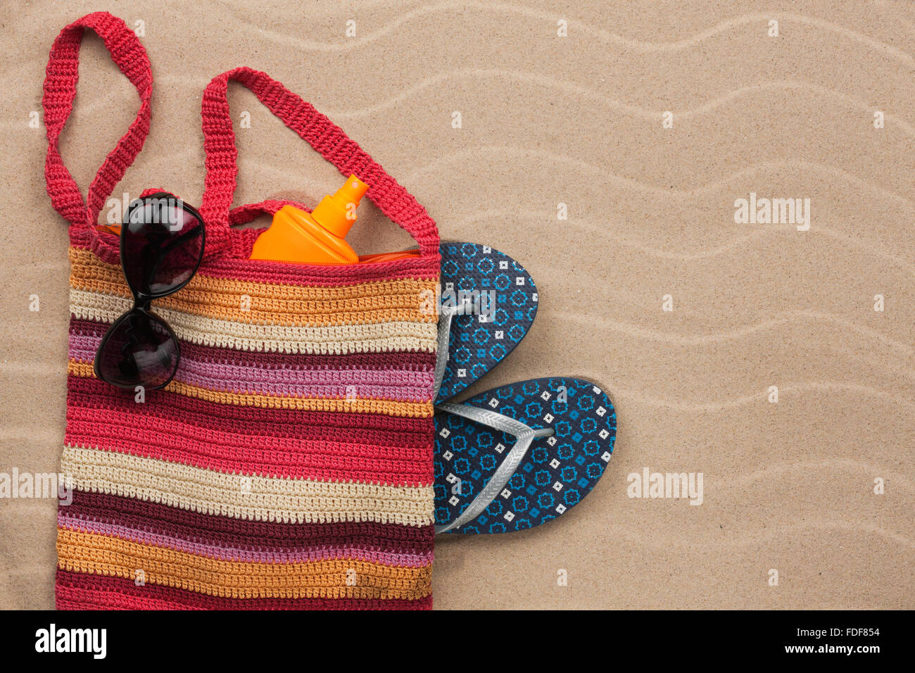 Beach bag with sunscreen, flip flops, sunglasses. Summer holiday ...