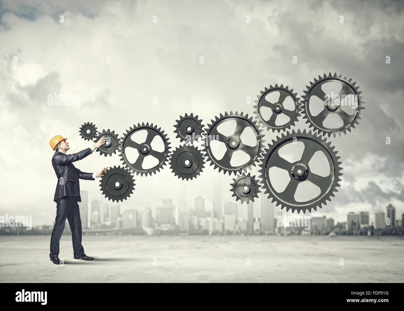 Businessman with cog wheel elements. Construction concept Stock Photo ...