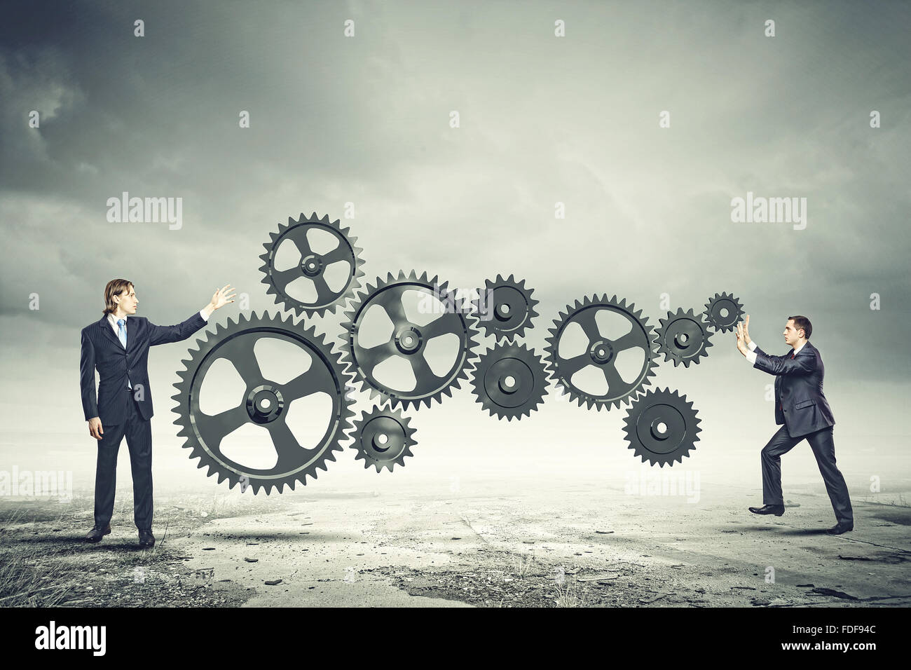 Businessman with cog wheel elements. Construction concept Stock Photo ...
