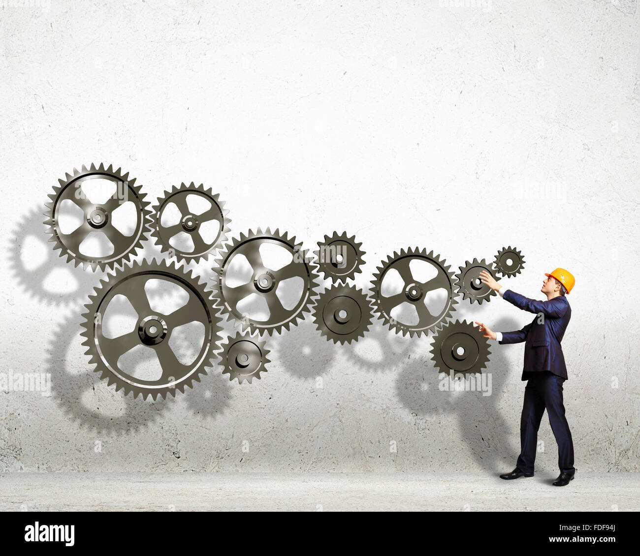 Businessman with cog wheel elements. Construction concept Stock Photo ...