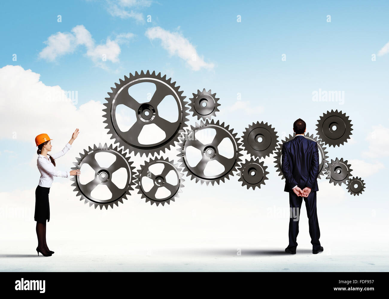 Businessman and businesswoman with cog wheel elements. Organization ...