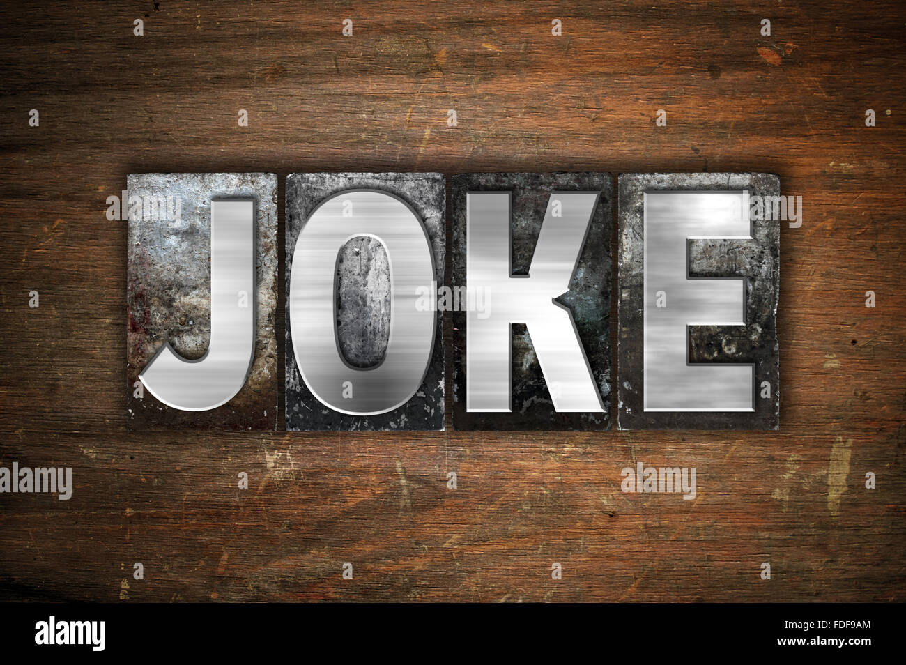 The word "Joke" written in vintage metal letterpress type on an aged ...
