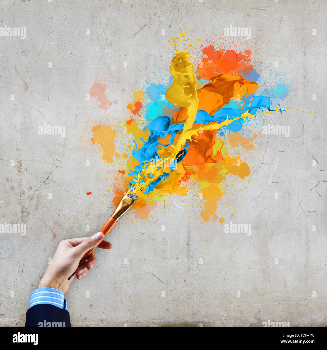 Close-up of human hand holding paint brush making colorful paint ...