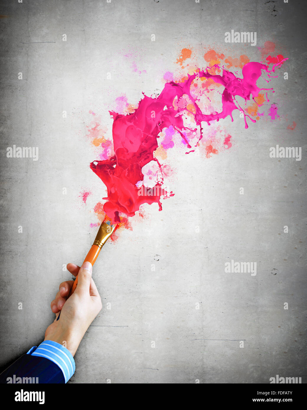 Close-up of human hand holding paint brush making colorful paint ...