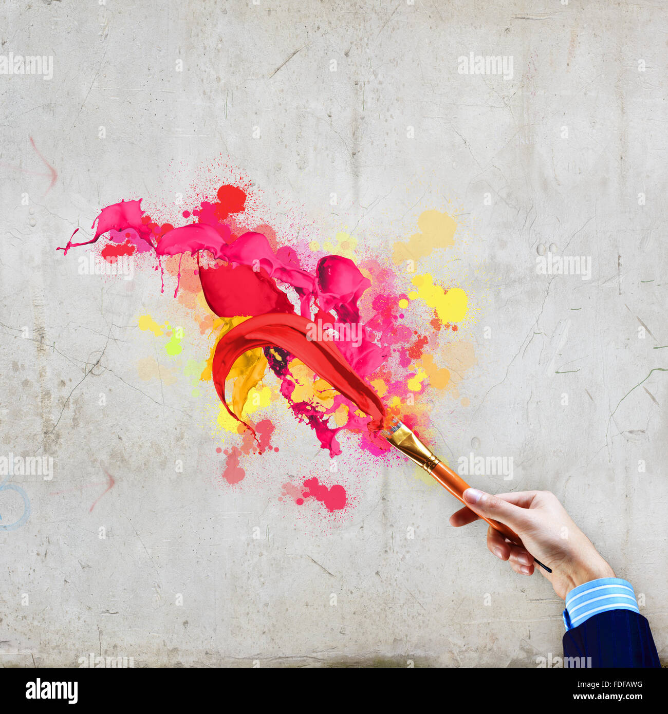 Close-up of human hand holding paint brush making colorful paint ...
